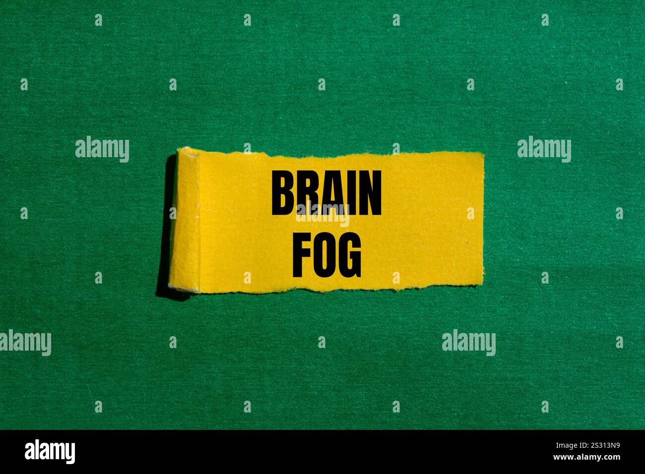 Brain fog message written on ripped torn yellow paper piece with green ...