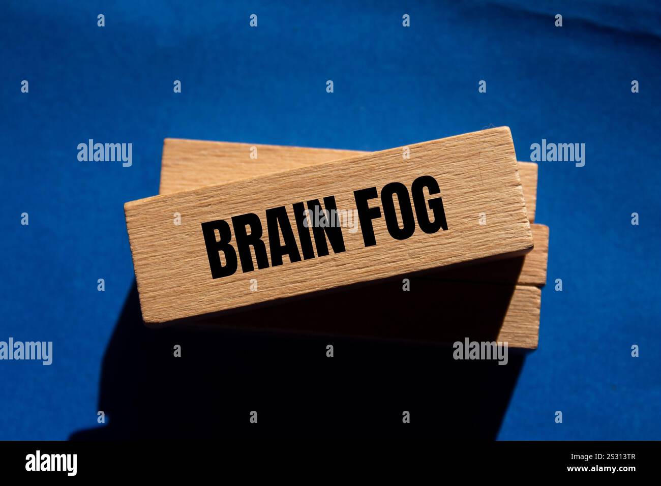 Brain fog message written on wooden blocks with blue background ...