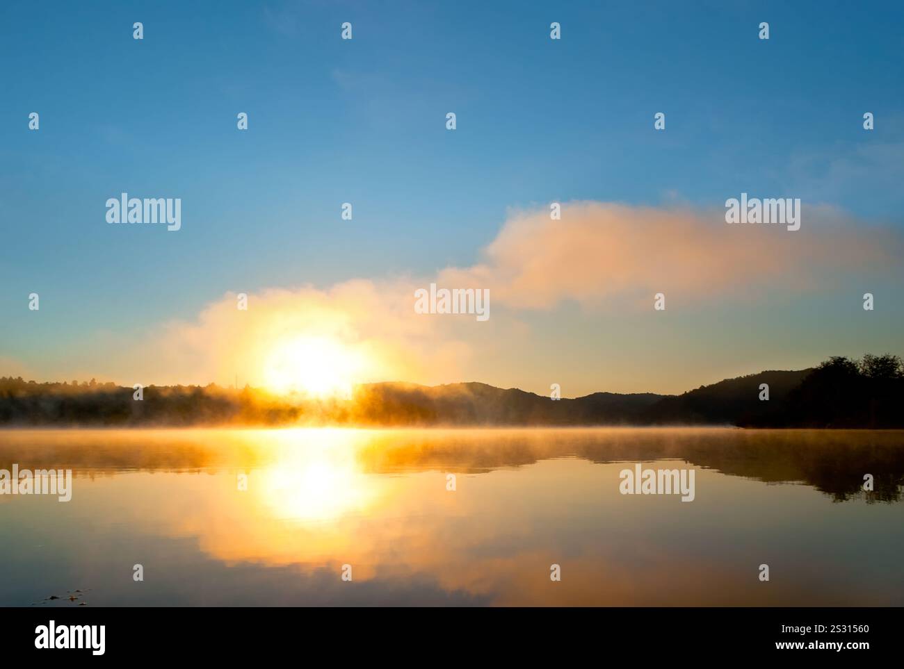 The beautiful sunrise and its reflection on steamy Lake Mladost, Veles ...