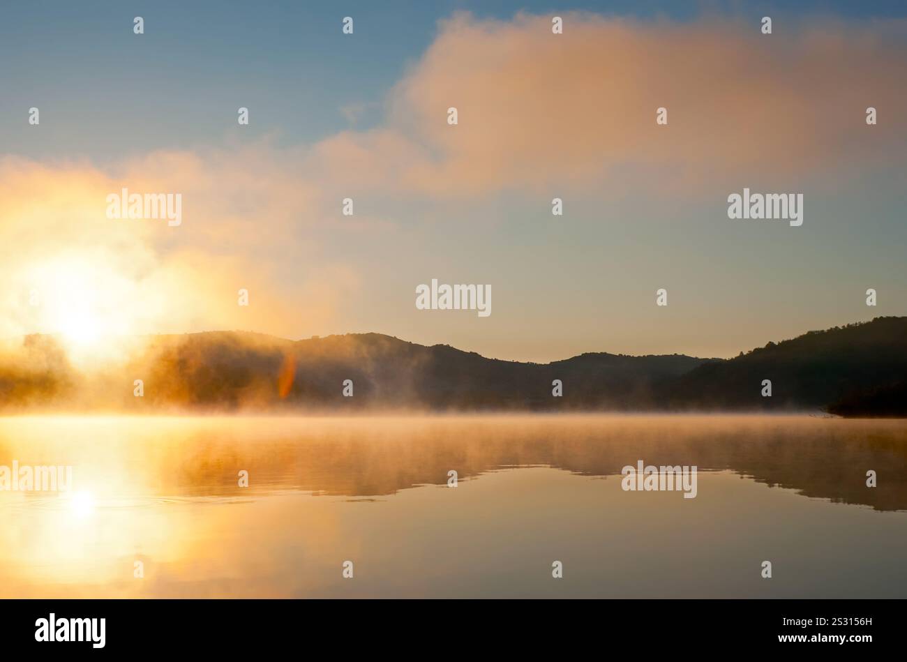 The steam rising from Lake Mladost glows golden in the light of the ...