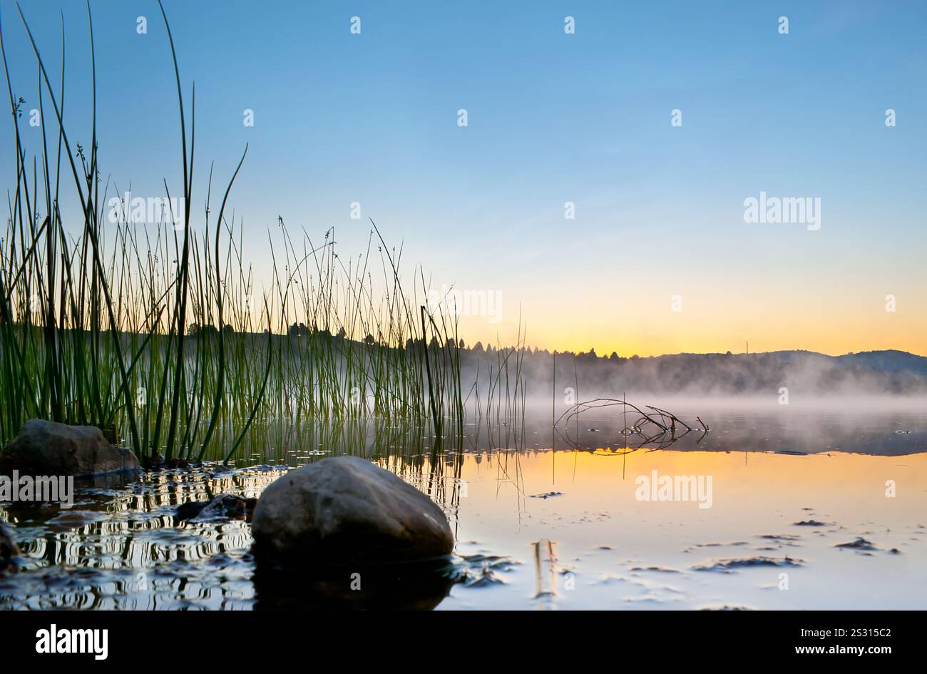 The low angle view of the mirror like surface of Lake Mladost ...
