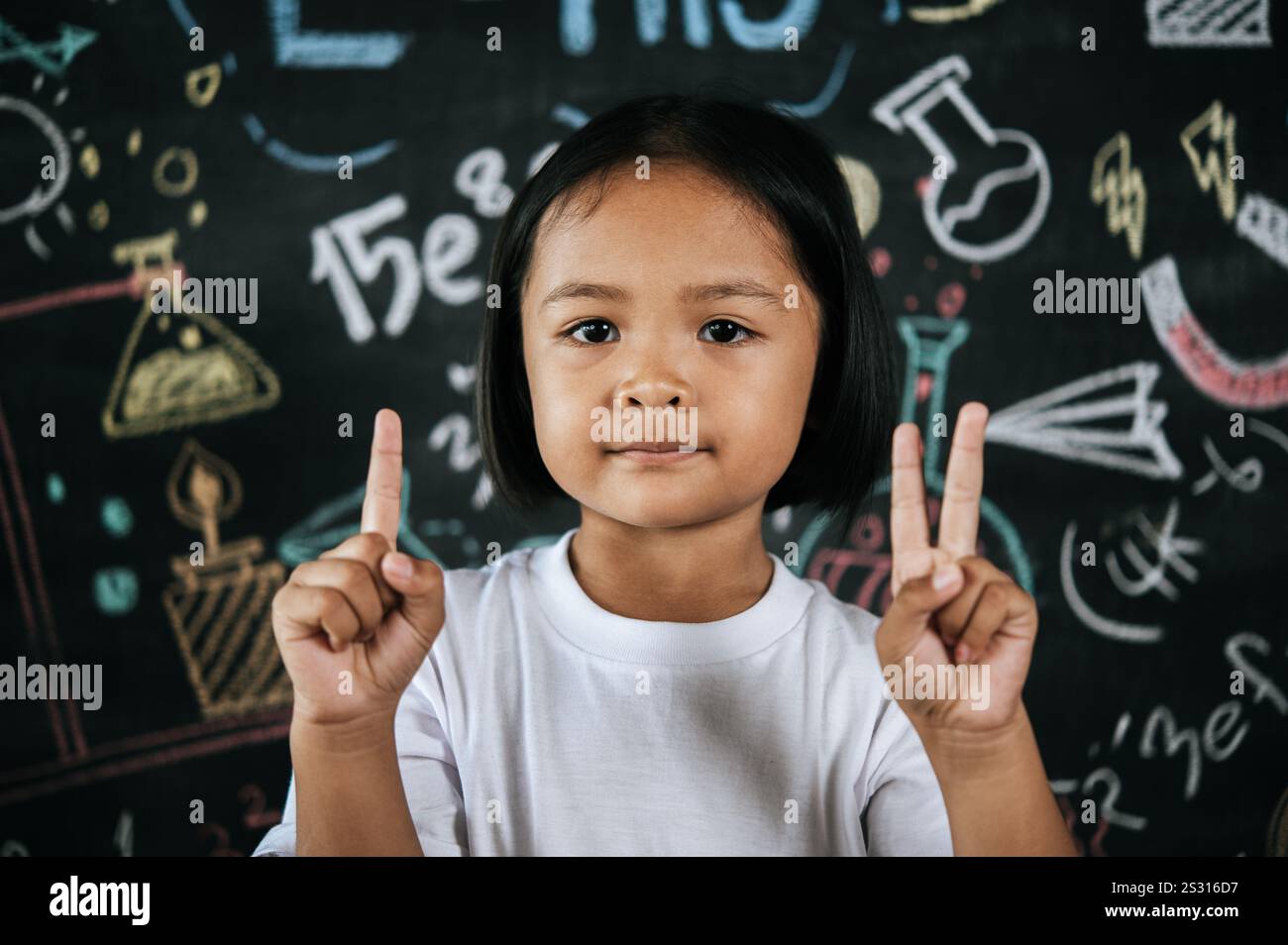 Portrait Little girl standing and show her finger with counting number ...