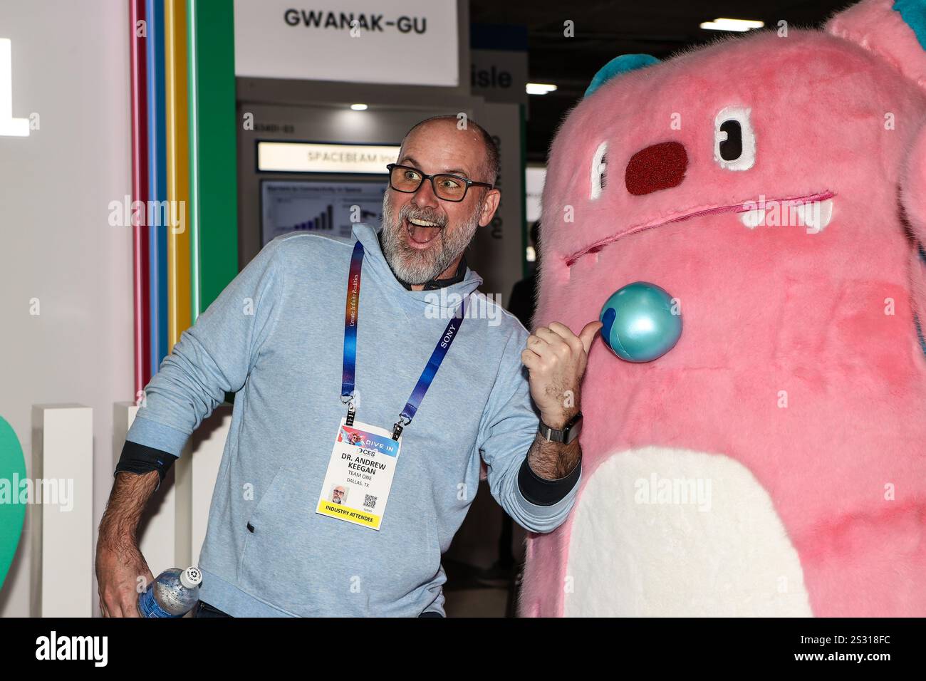 January 7, 2025: An attendee pose for a photo with a mascot during the ...