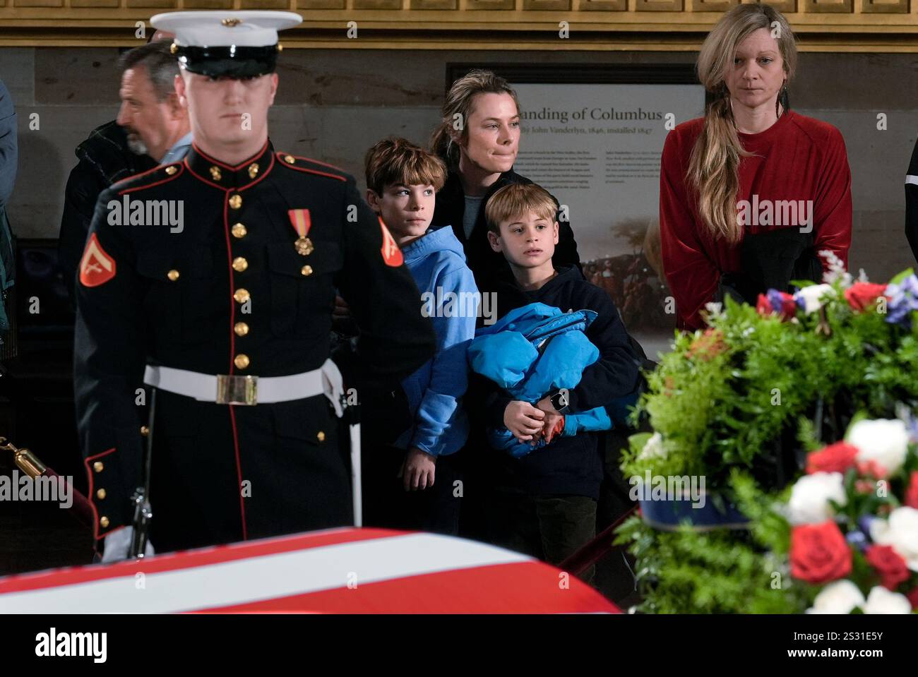 Liz Bartlett of Alexandria, Va., stands between her sons Henry, left ...