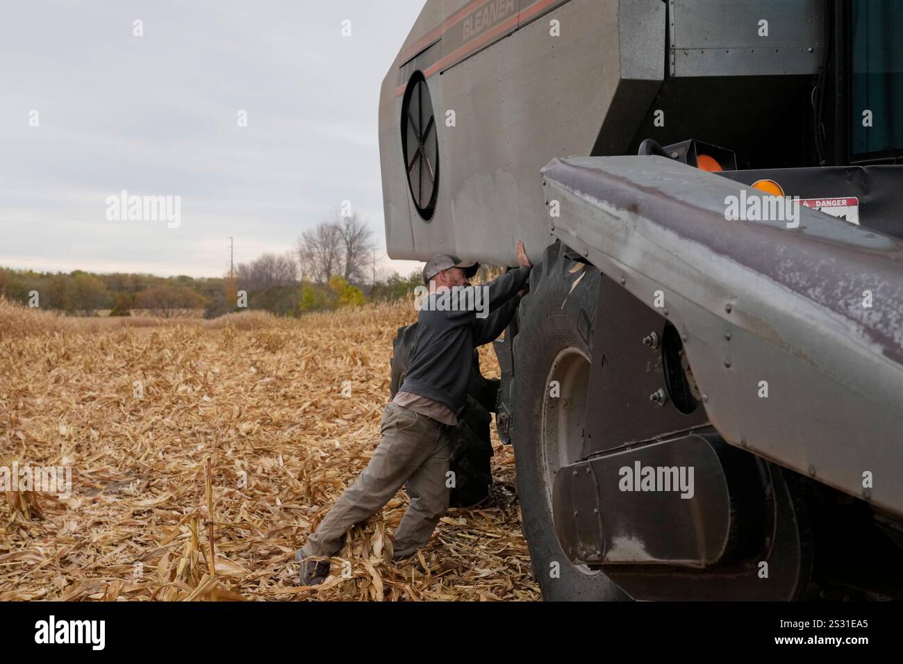 Martin Larsen examines his combine after harvesting corn, Friday, Oct ...