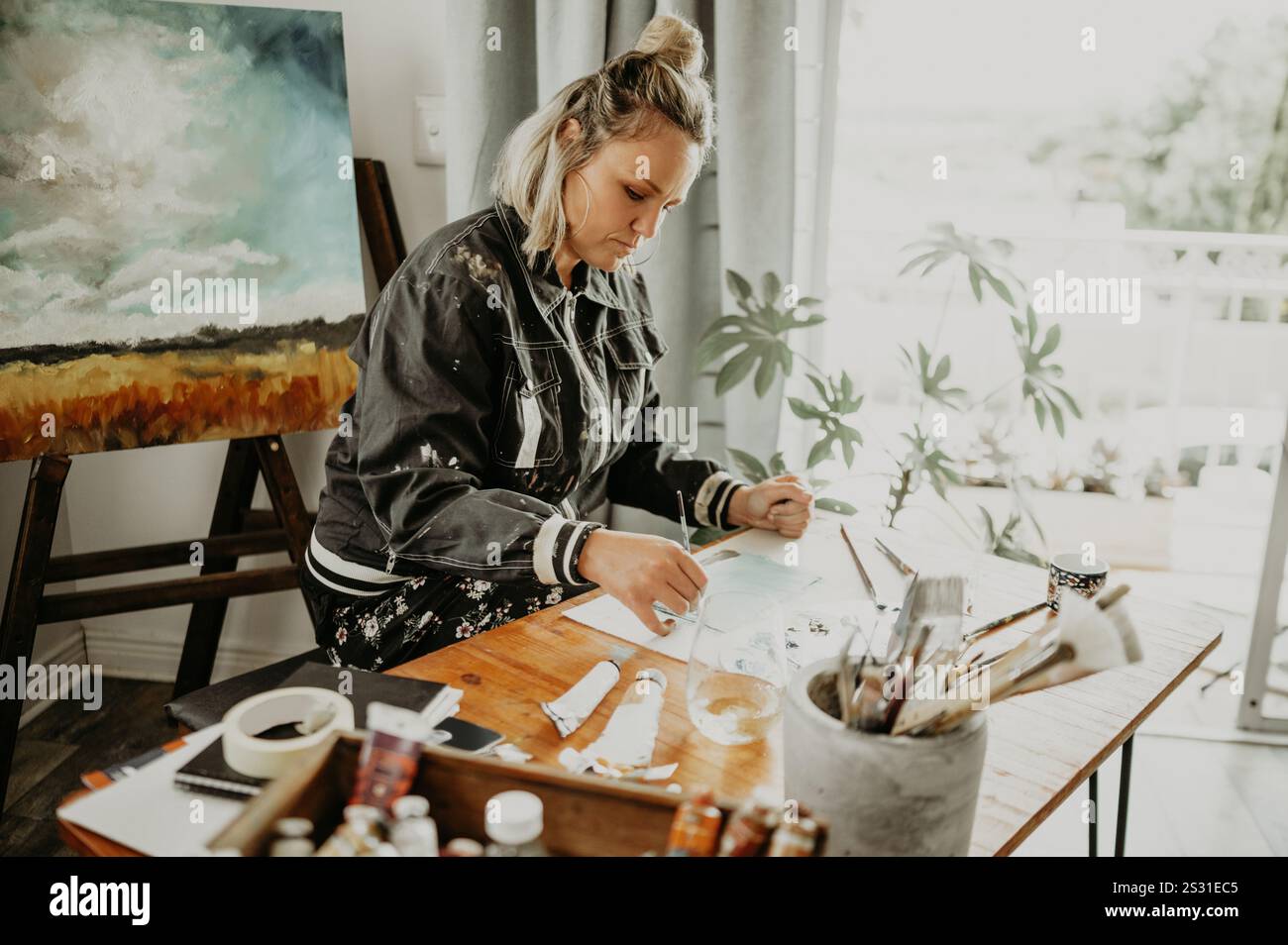 Creative, drawing art and woman in studio at desk for painting hobby ...