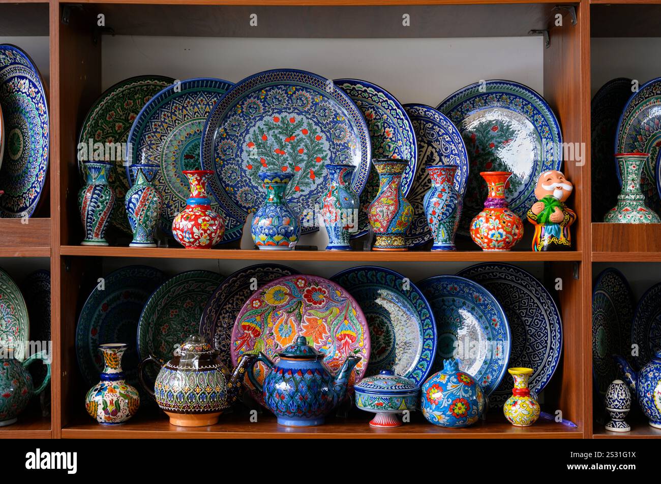 Colorful plates, kettles, jugs and souvenirs with national Uzbek ...