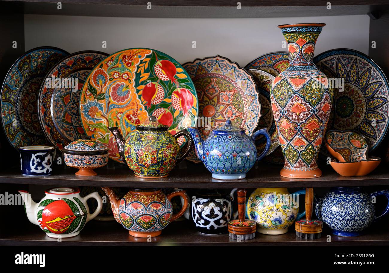Colorful teapots, plates, kettles, jugs and souvenirs with national ...