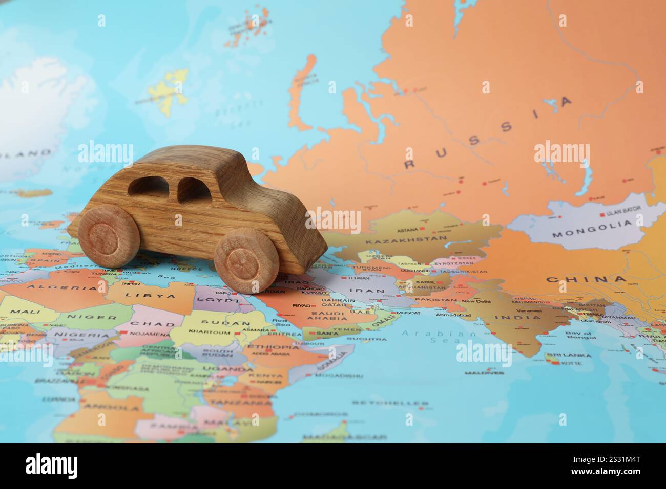 Wooden toy car on world map. Road trip Stock Photo - Alamy