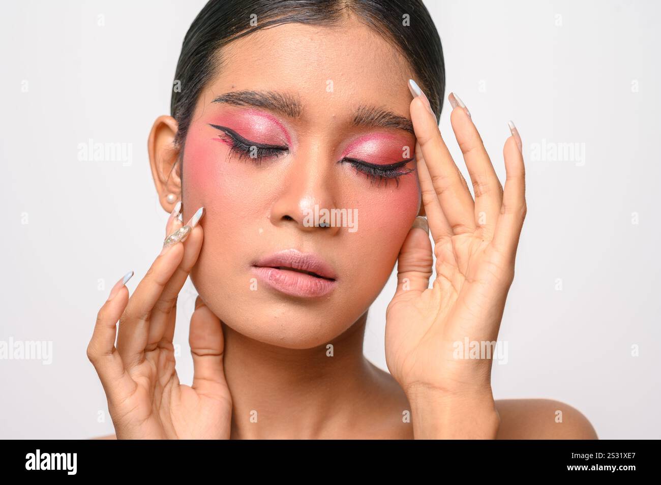 The woman put on pink makeup and put her hand on her face. Isolated on ...