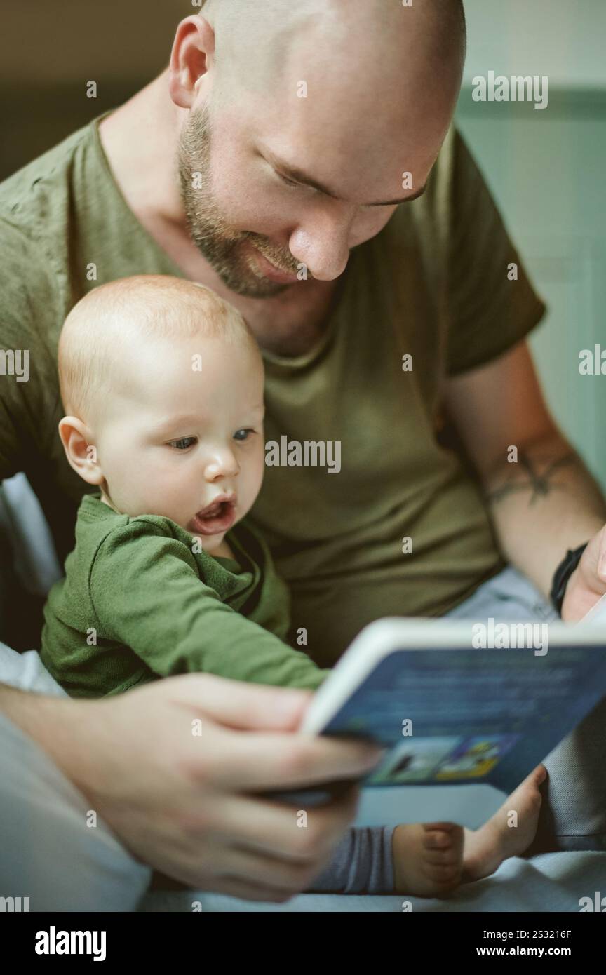 Family, father with baby and reading book with learning storytelling ...