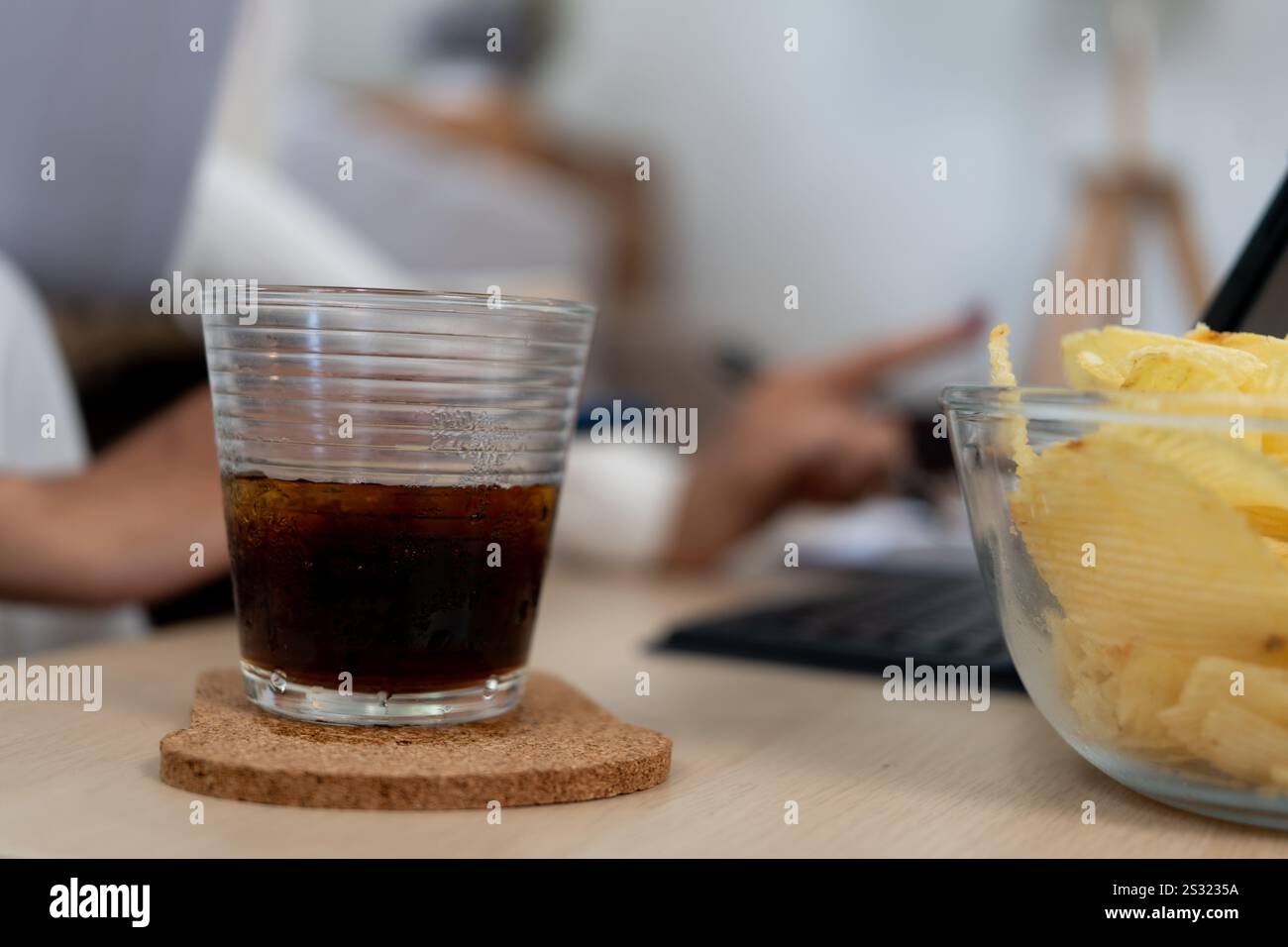 Female higher education student using laptop and studying book in home ...