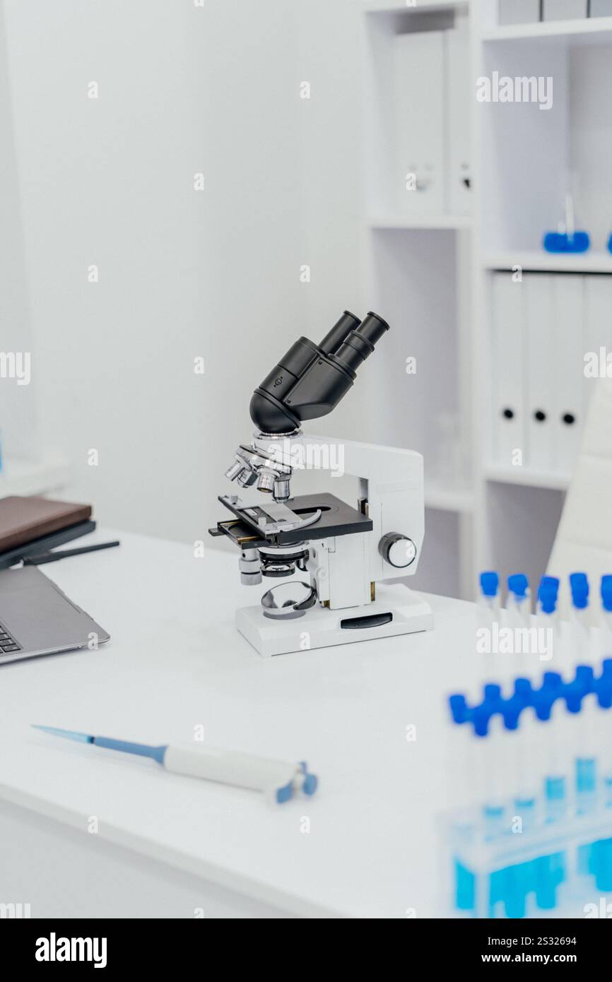 A modern laboratory setup featuring a high-powered microscope ...