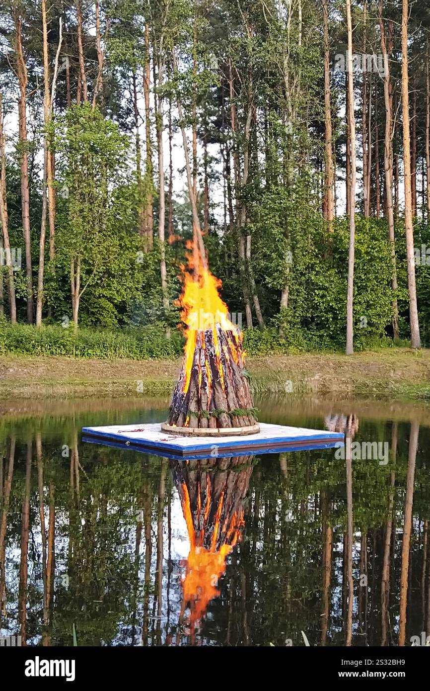 Stunning midsummer bonfire burning on floating platform in the middle ...