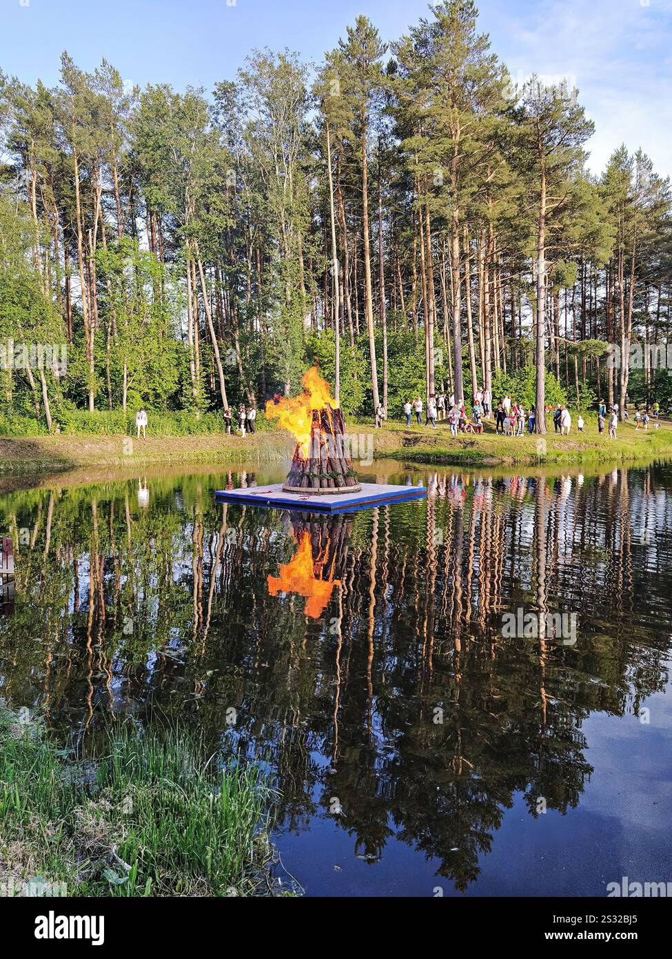 Stunning midsummer bonfire burning on floating platform in the middle ...