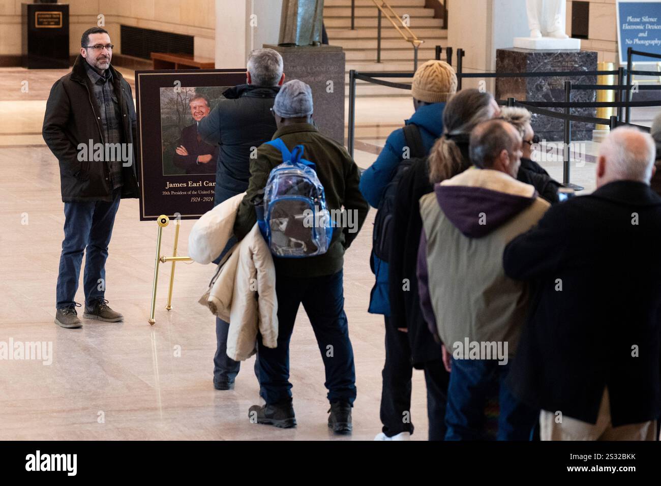 UNITED STATES - JANUARY 8: Visitors pose for photos by a photo of ...
