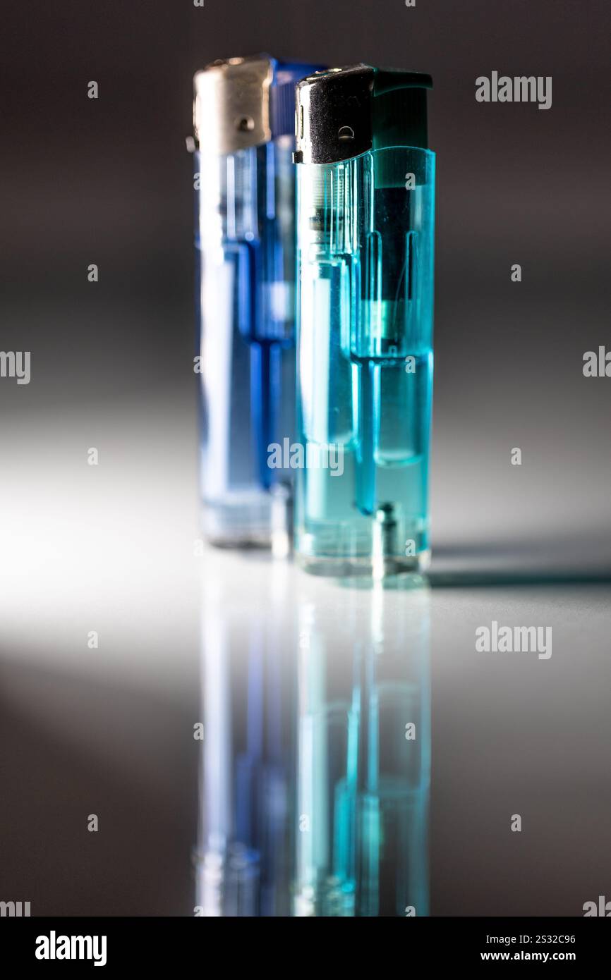 Two lighters in vibrant dark and light blue shades stand side by side ...
