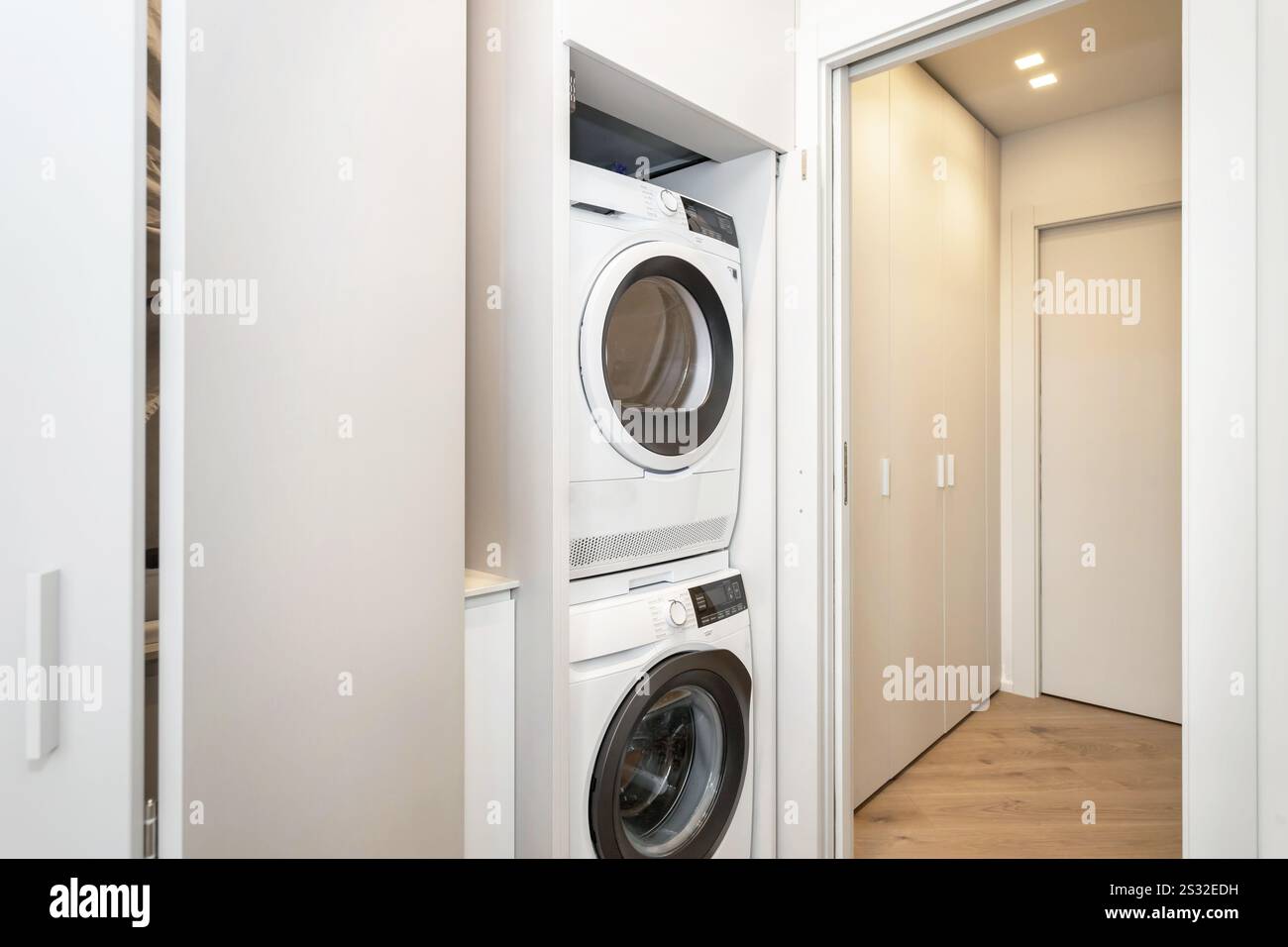 Interior of modern laundry room with washing machines and clothes dryer ...