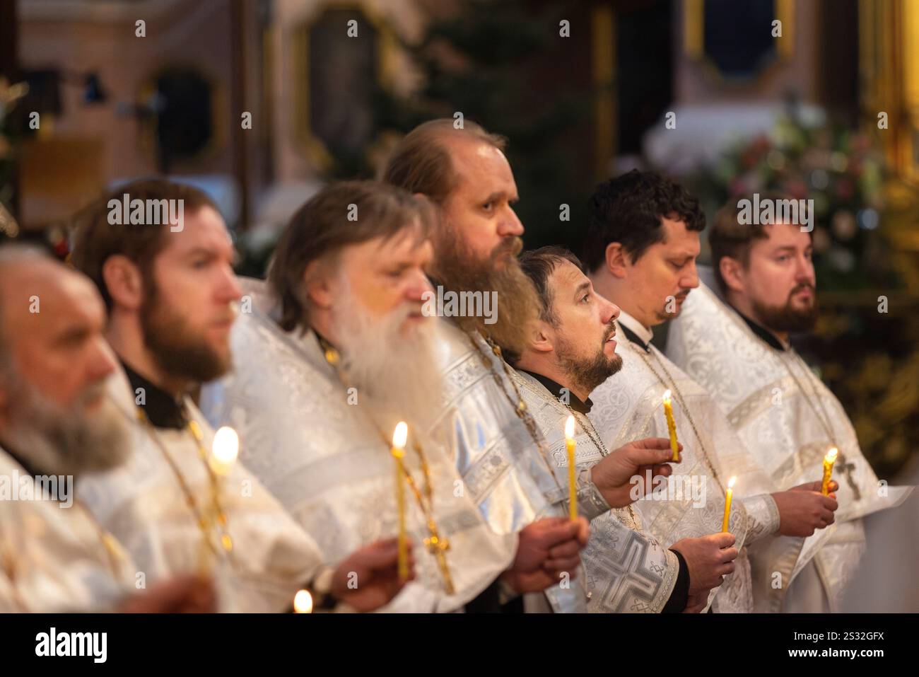 Orthodox priests hold candles and pray during the funeral ceremony of ...