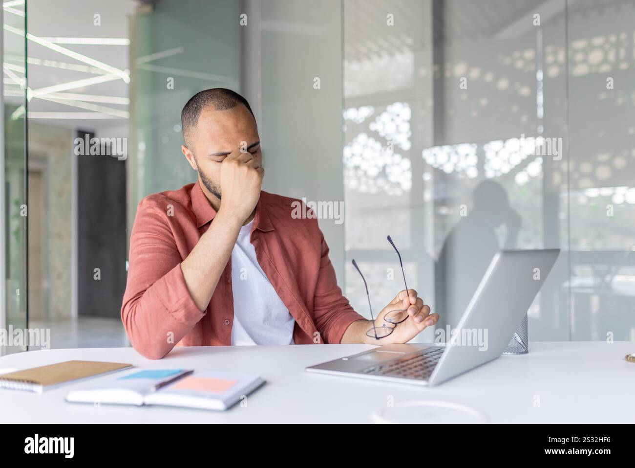 Man has severe headache and dizziness at workplace inside office ...