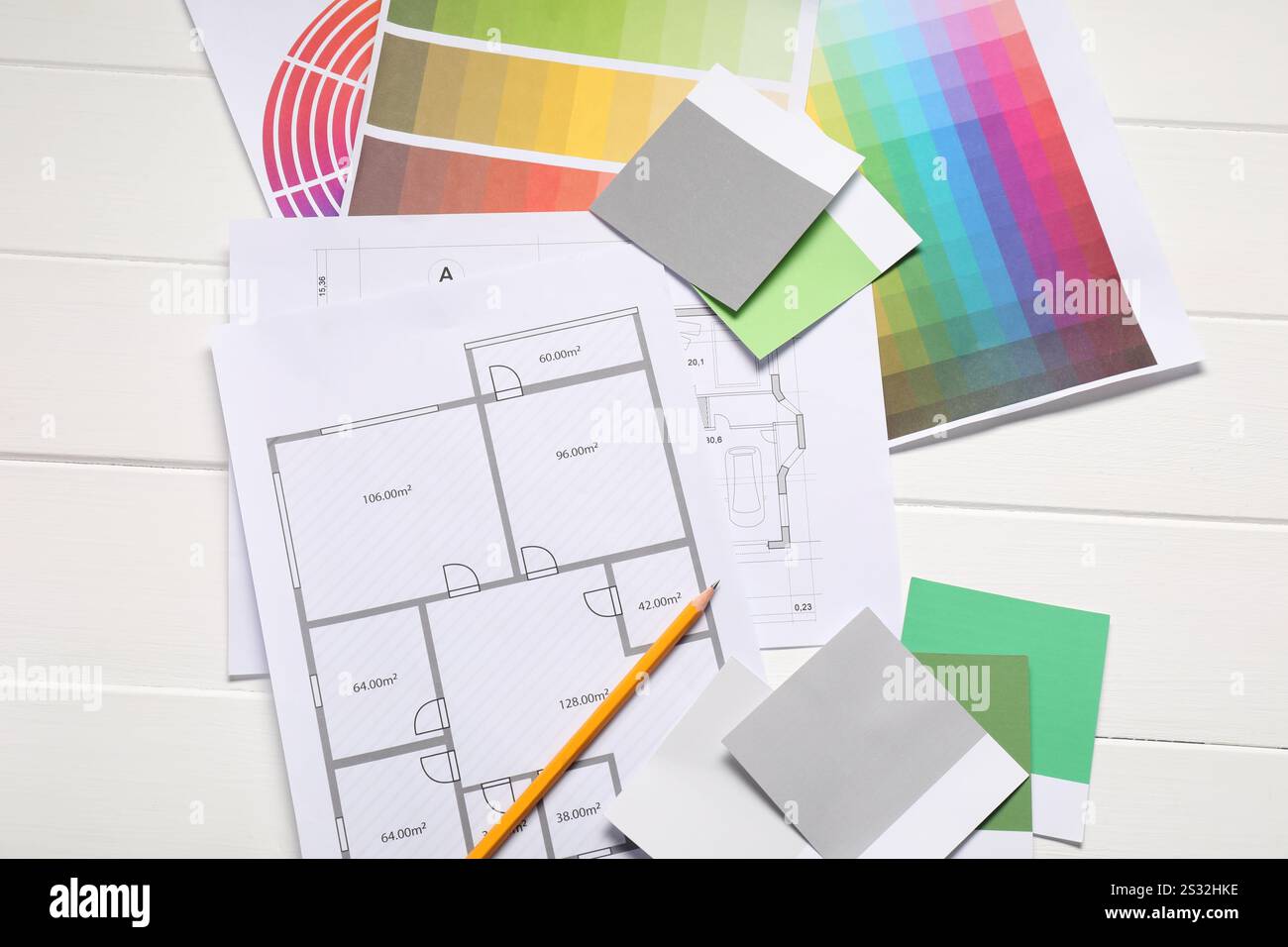 Designer's workplace with color palettes, floor plans and pencil on ...