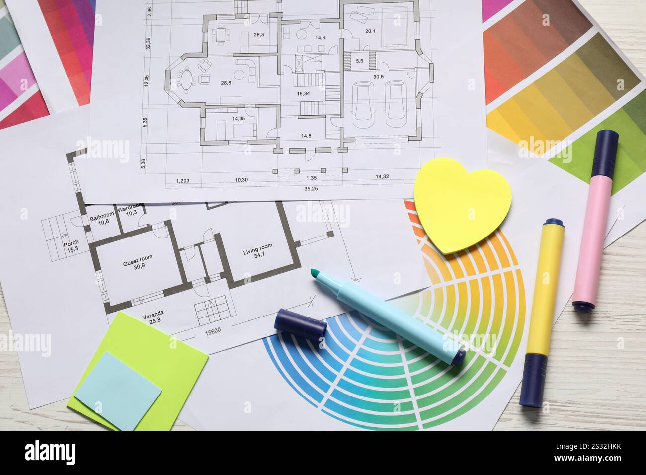 Designer's workplace with house plans, color palettes and stationery on ...