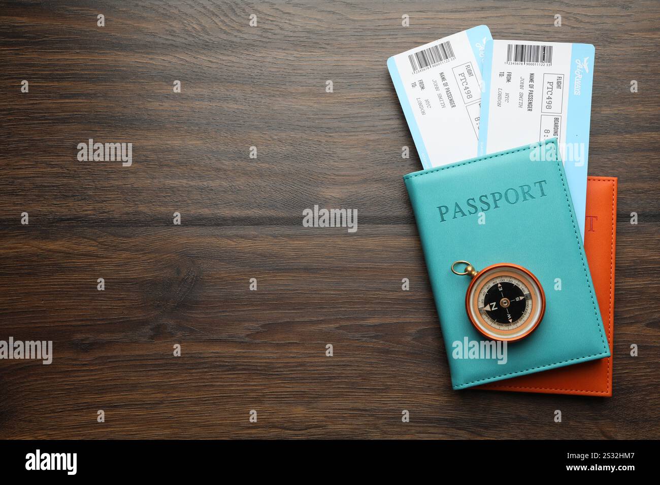 Travel agency. Flight tickets, passports and compass on wooden table ...