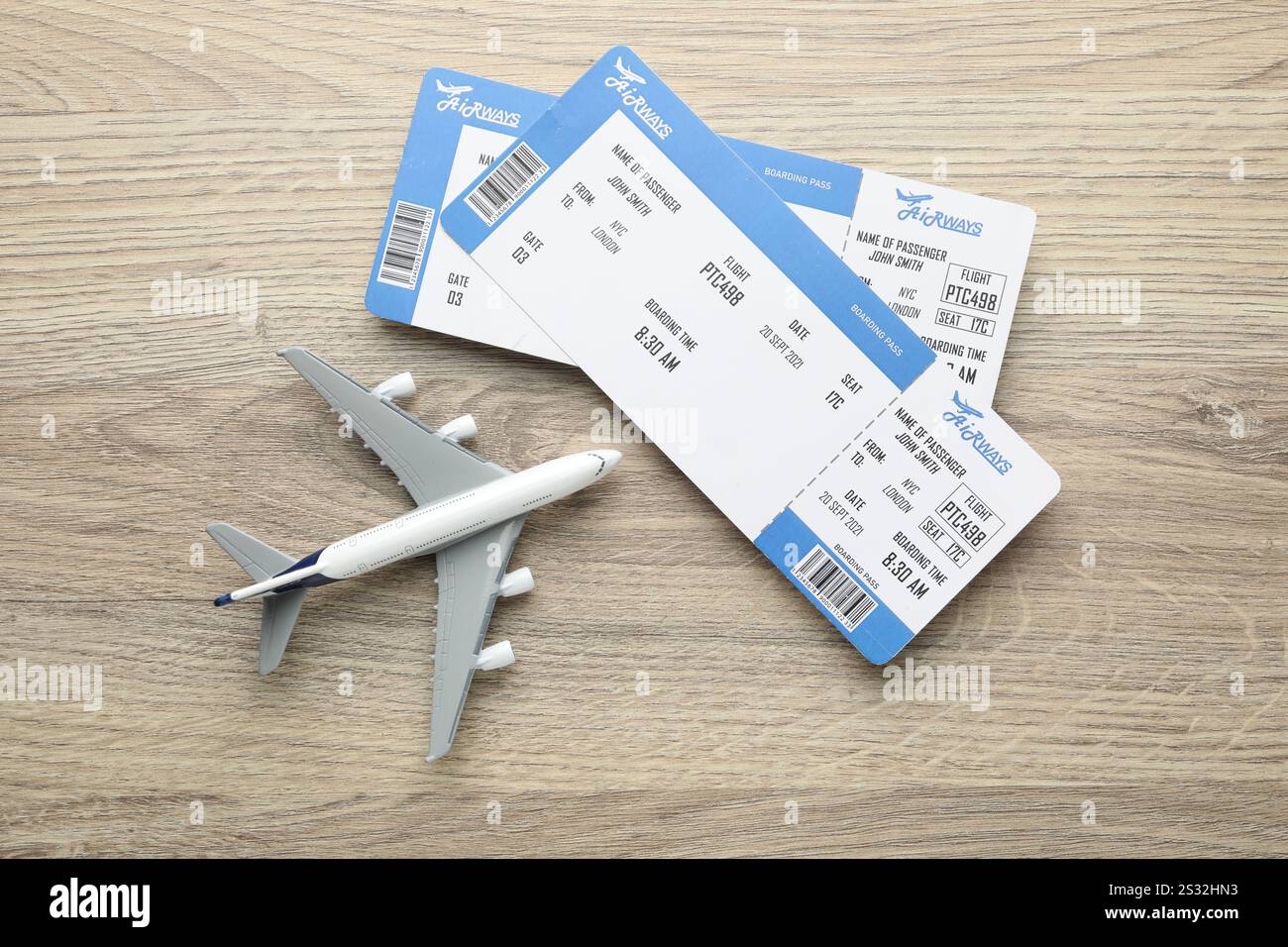 Travel agency. Flight tickets and plane model on wooden table, flat lay ...