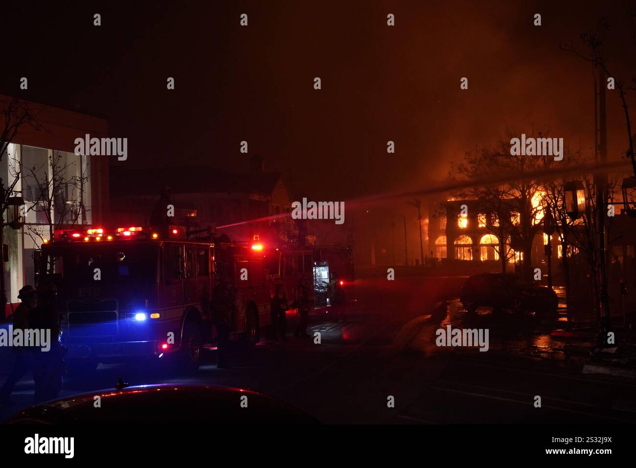 Firefighters battle with the fire as it burns in Pacific Palisades. The ...