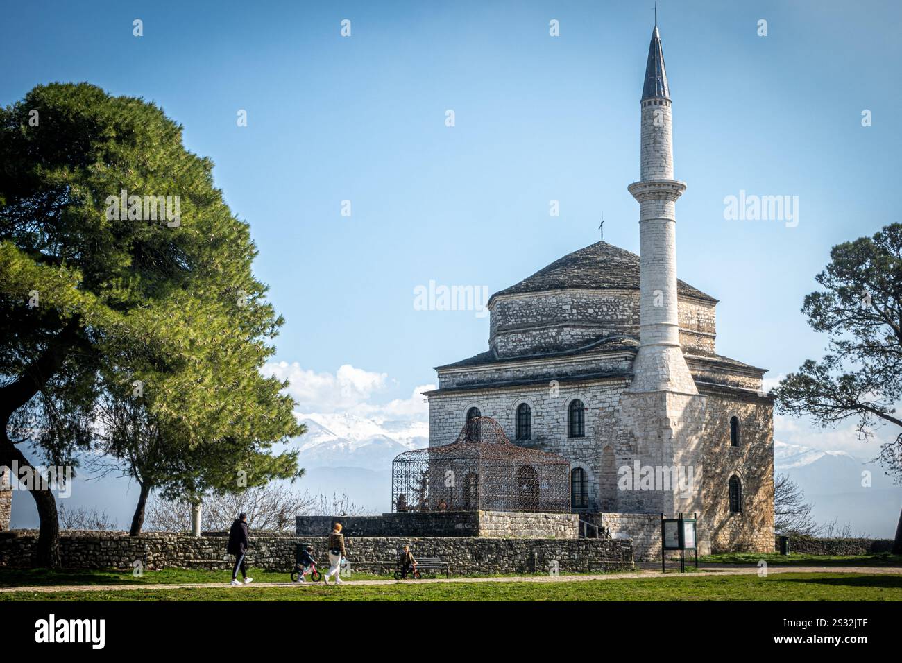 A beautiful mosque featuring a tall minaret stands majestically ...