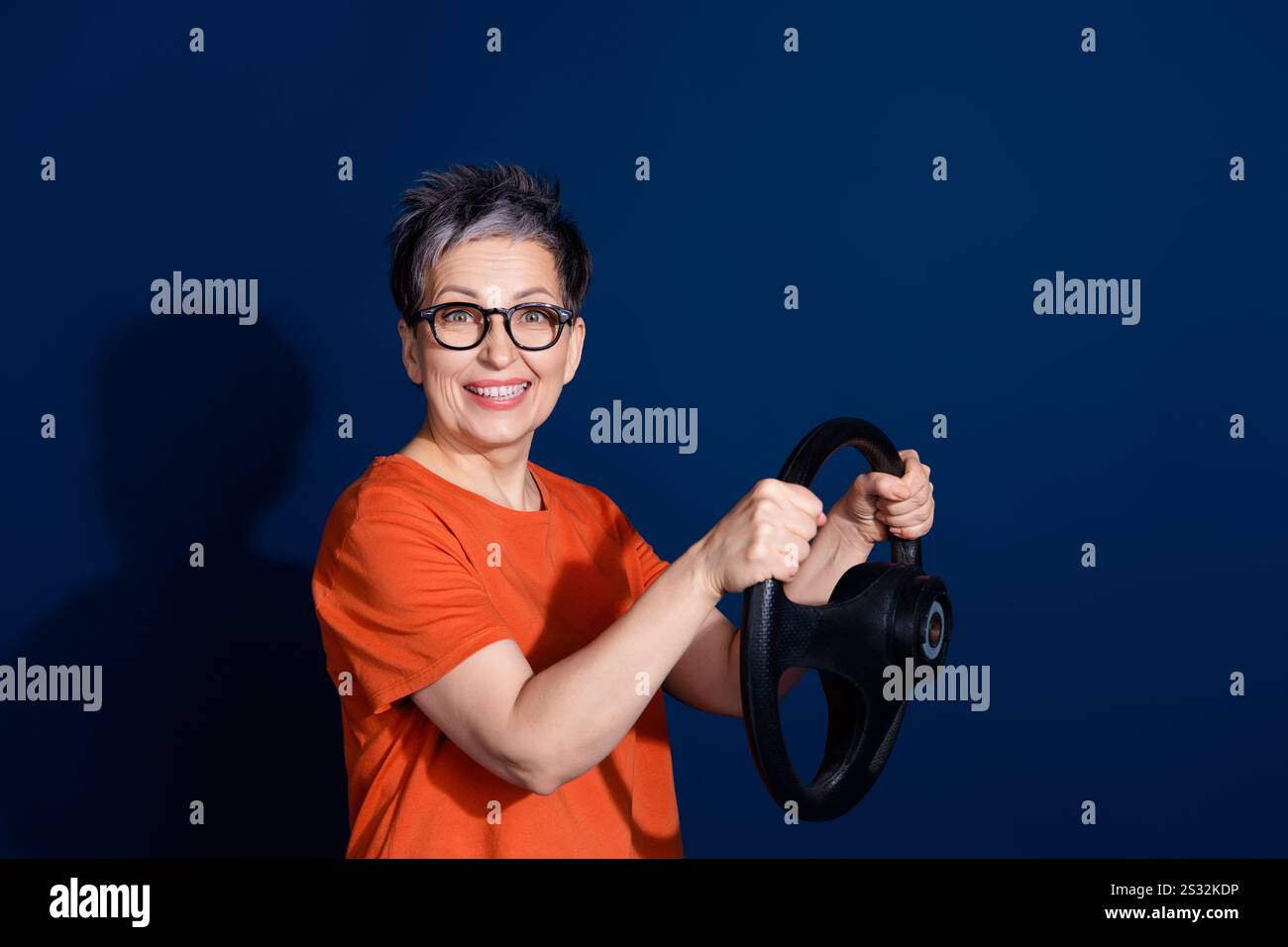 Photo portrait of pretty retired female driving car wear trendy orange ...