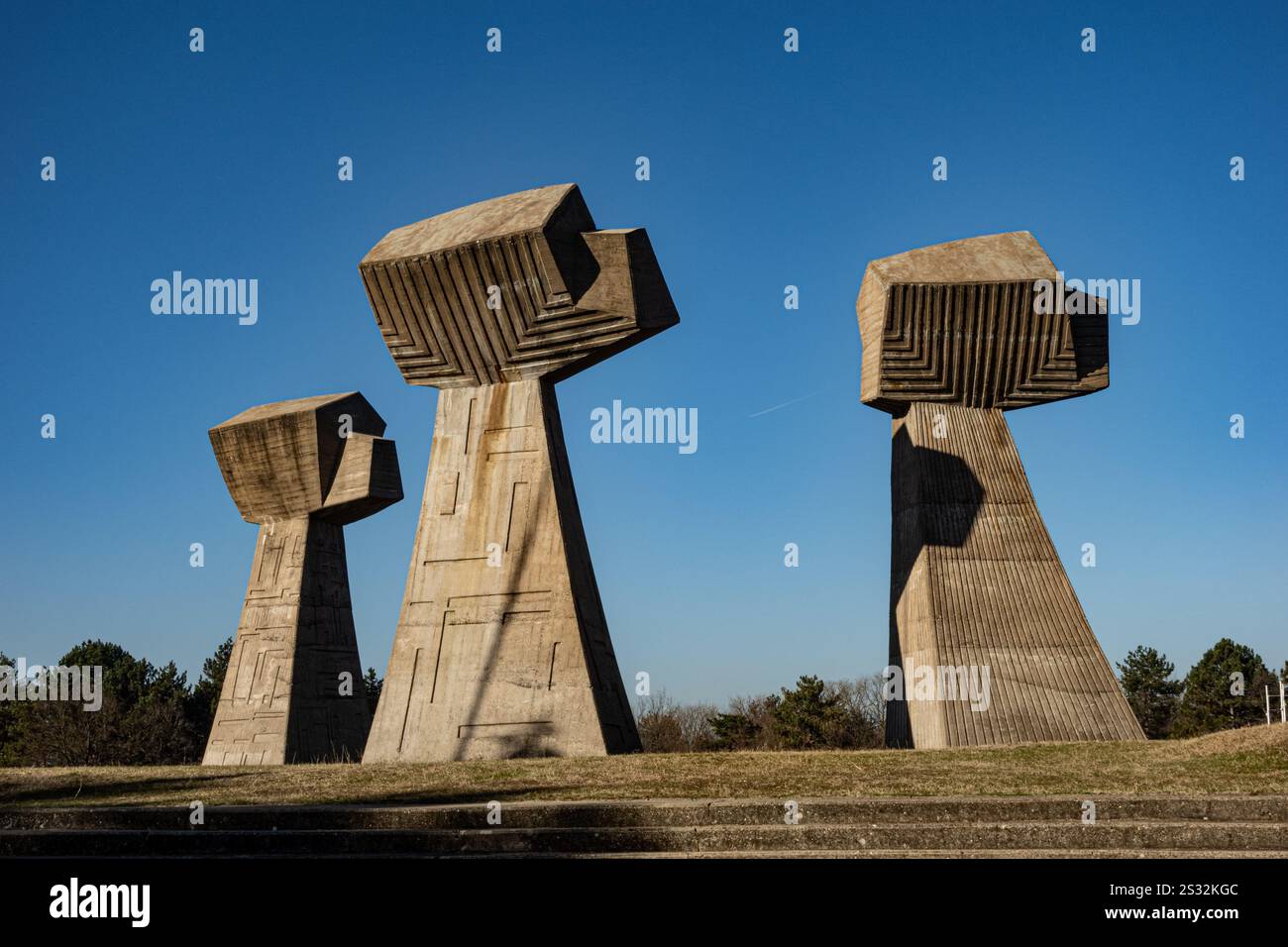 A beautiful row of unique concrete sculptures stands proudly against ...