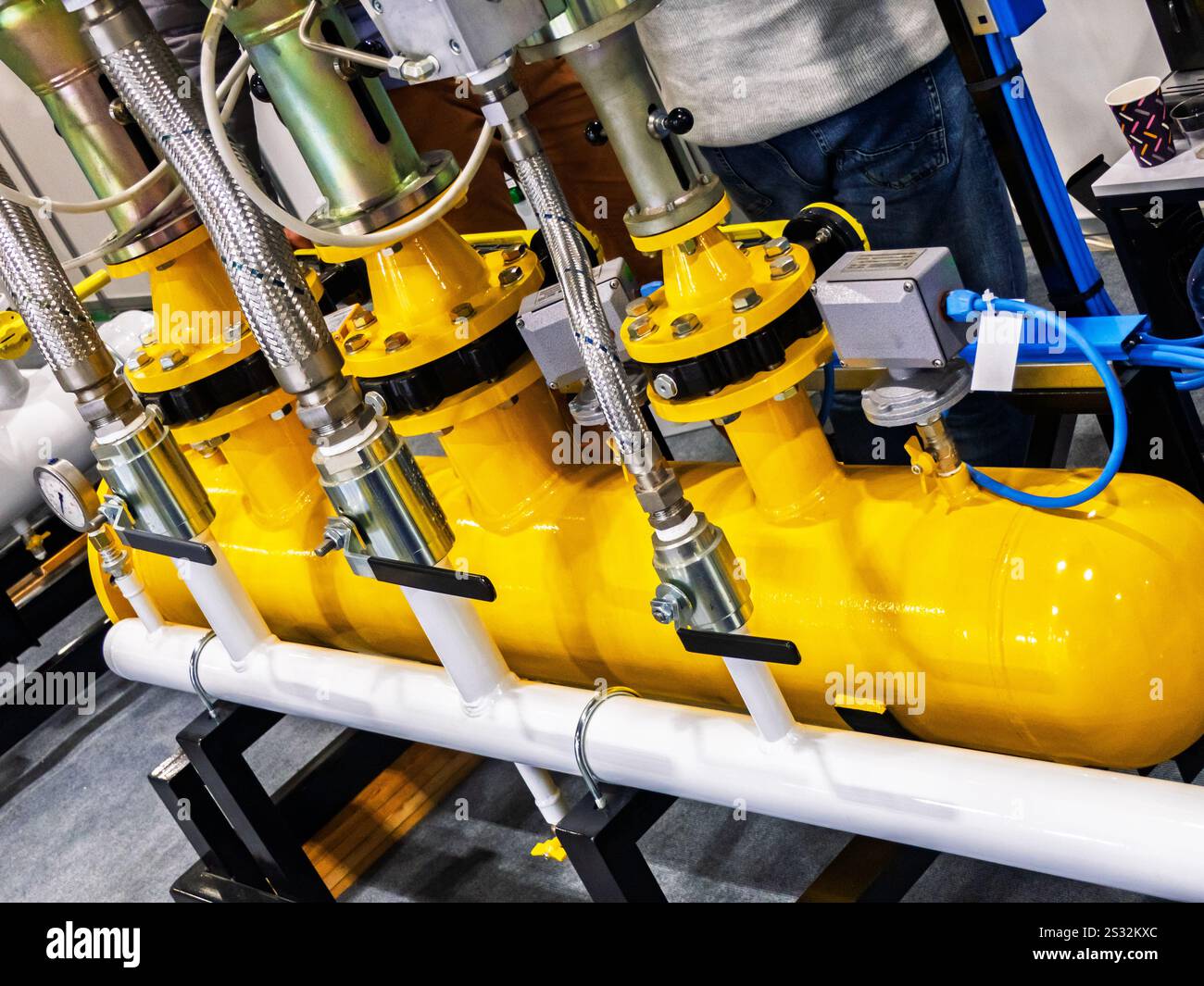 A close-up of an industrial gas or fluid control system. A prominent ...
