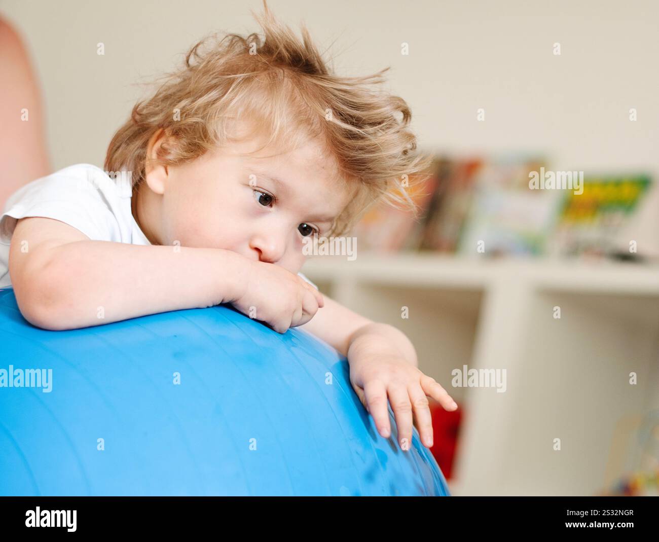 Portrait of a baby with cerebral palsy on physiotherapy in a children ...
