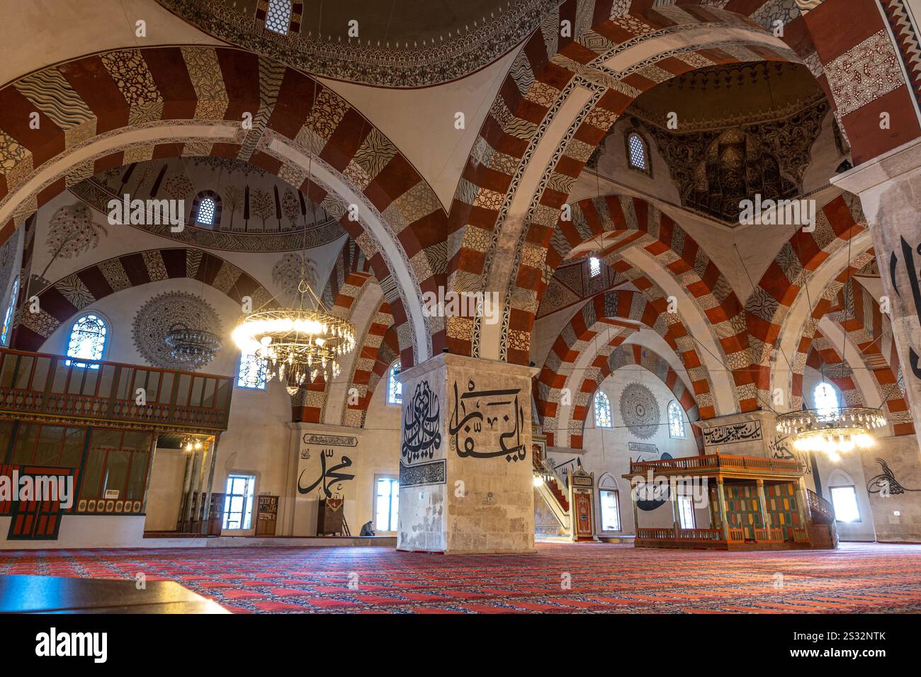 The interior space of a mosque features beautifully crafted arches and ...