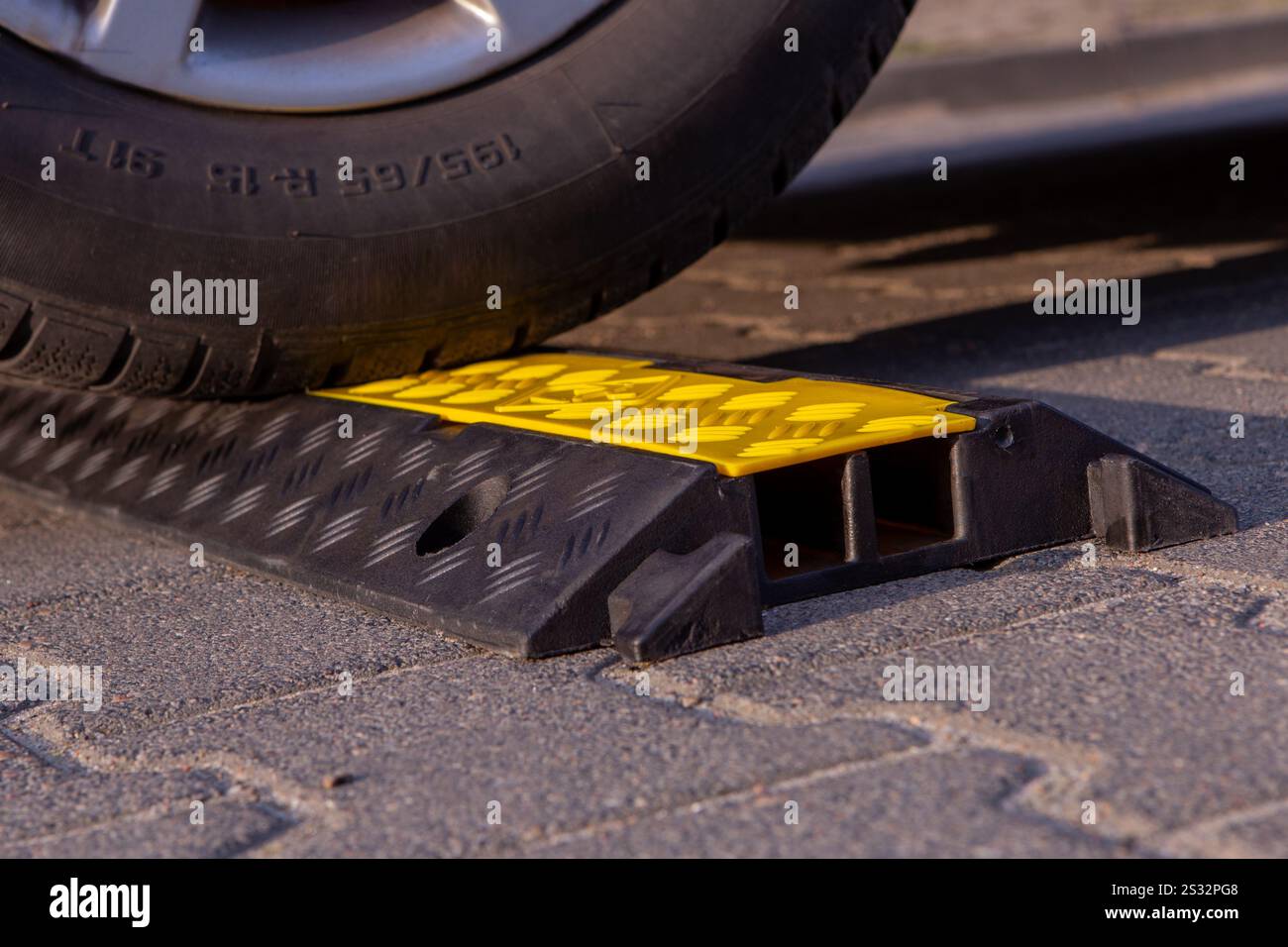 Car Wheel on Cable Protector Ramp Stock Photo - Alamy
