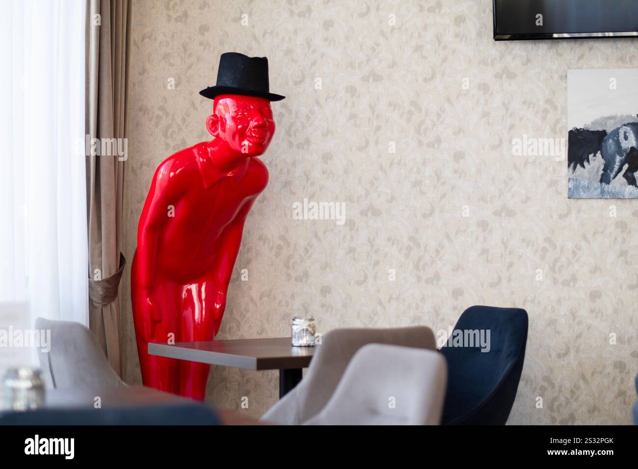 Smiling red greetingman. Bowing man fiberglass statue welcoming guests ...