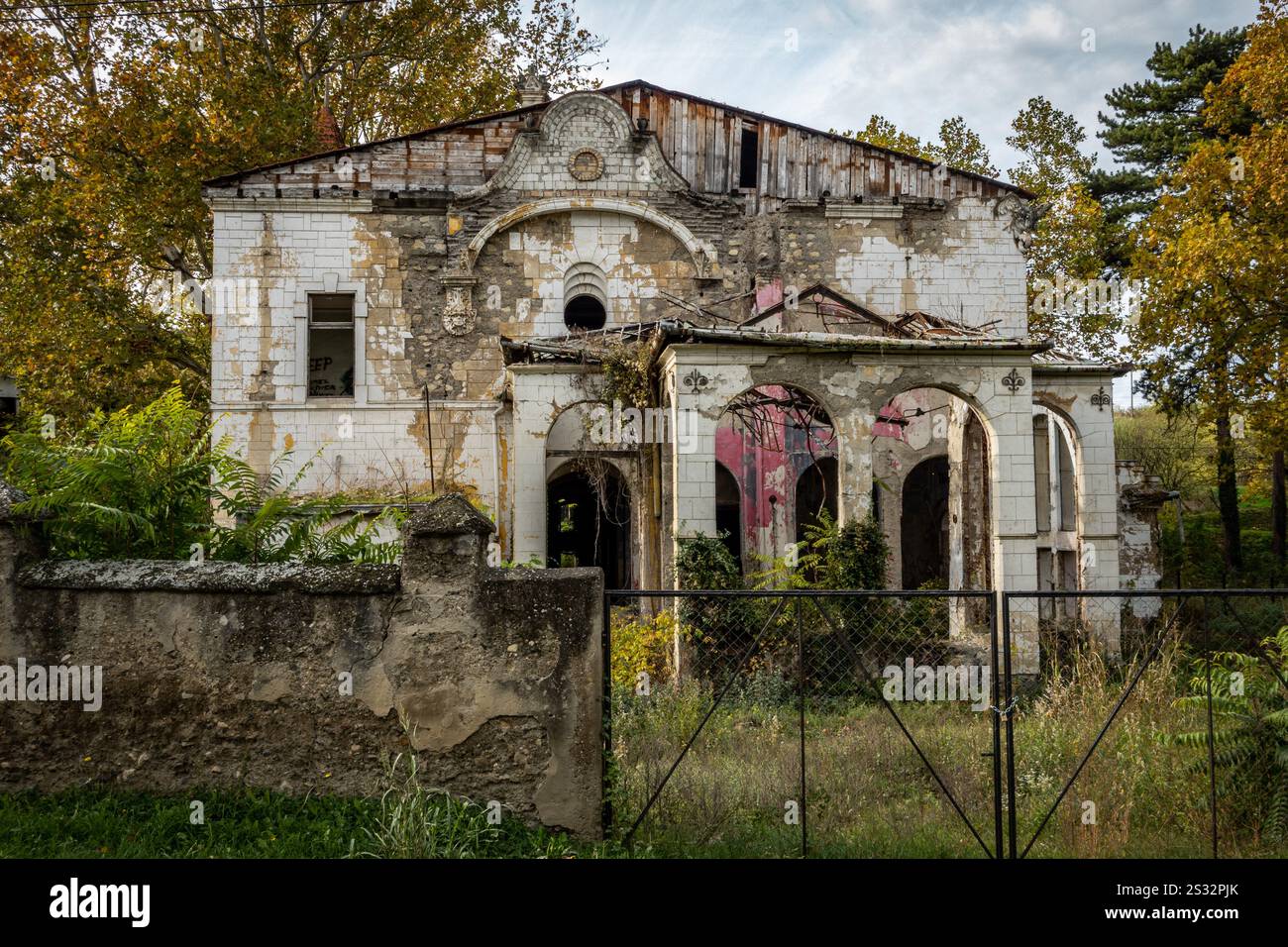 An old, neglected, and abandoned house, complete with a fence situated ...