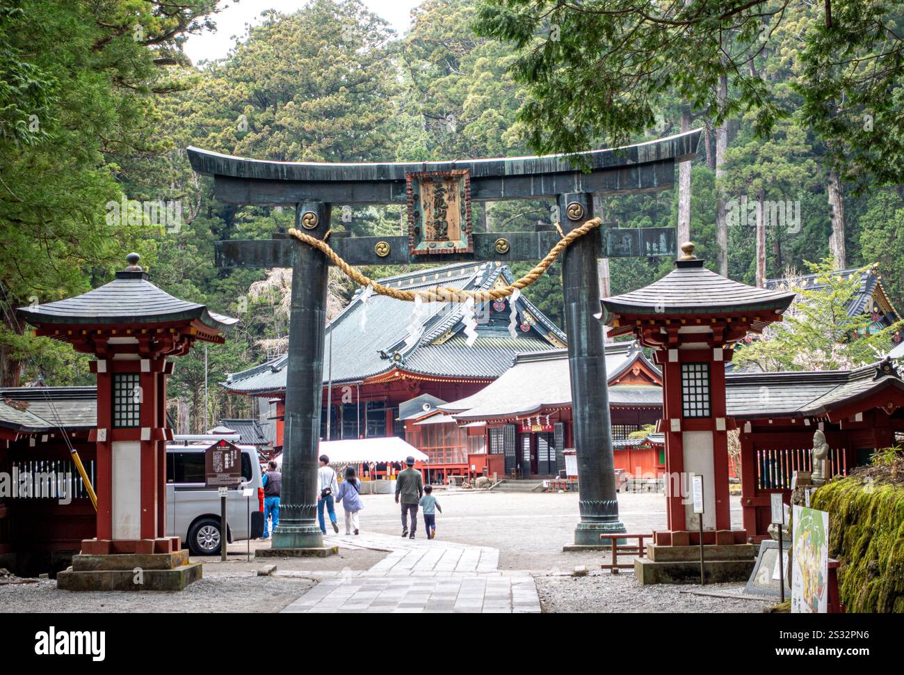 A diverse group of people are standing beneath a beautifully crafted ...