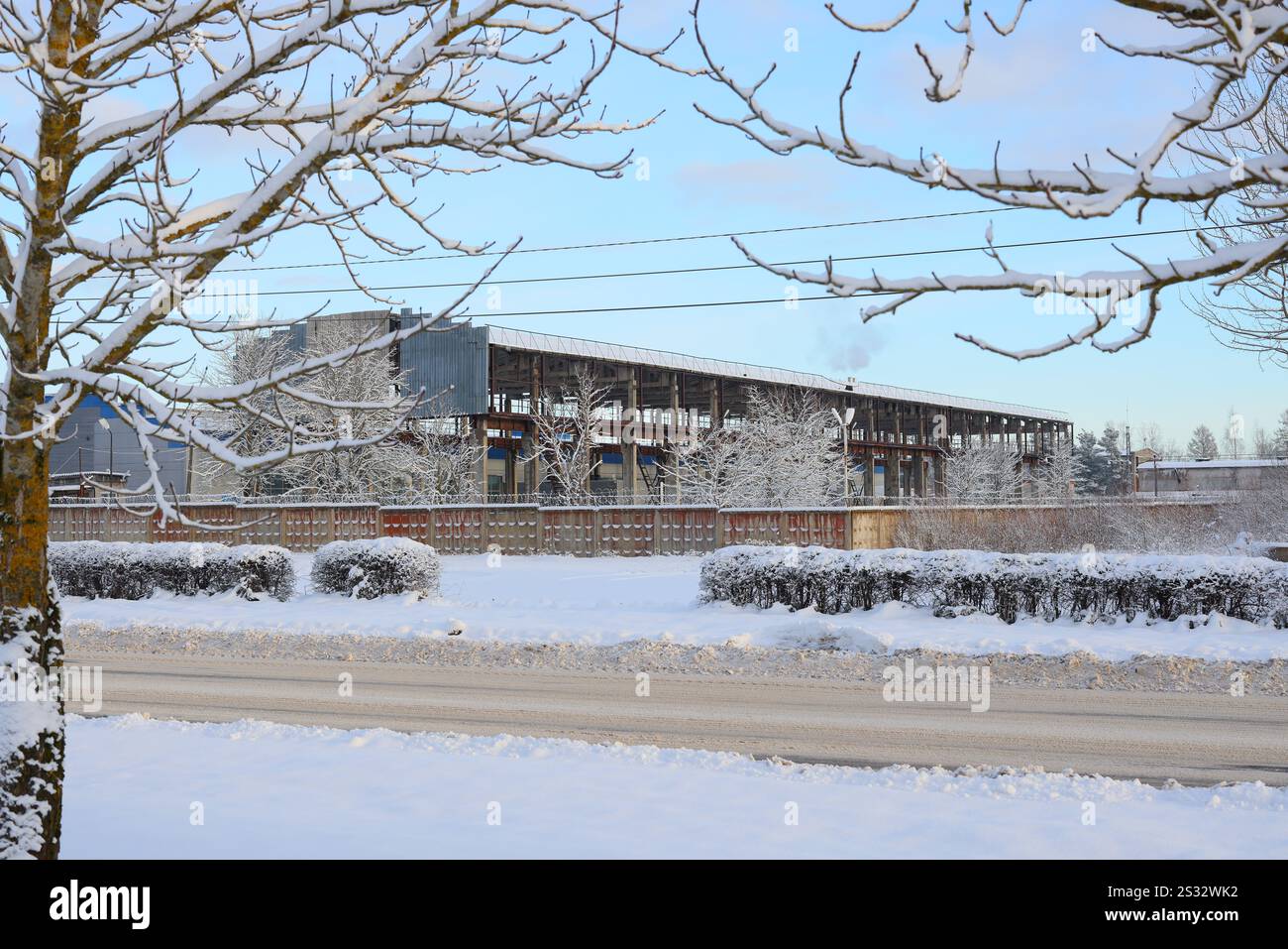 A picturesque winter scene featuring an industrial building set amidst ...