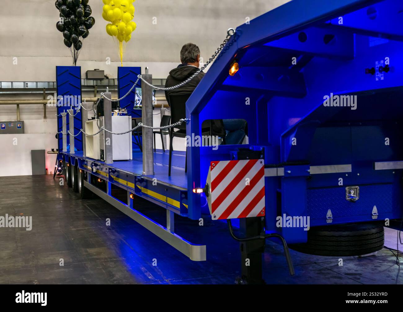 The rear of a large truck with a low-bed platform designed for ...