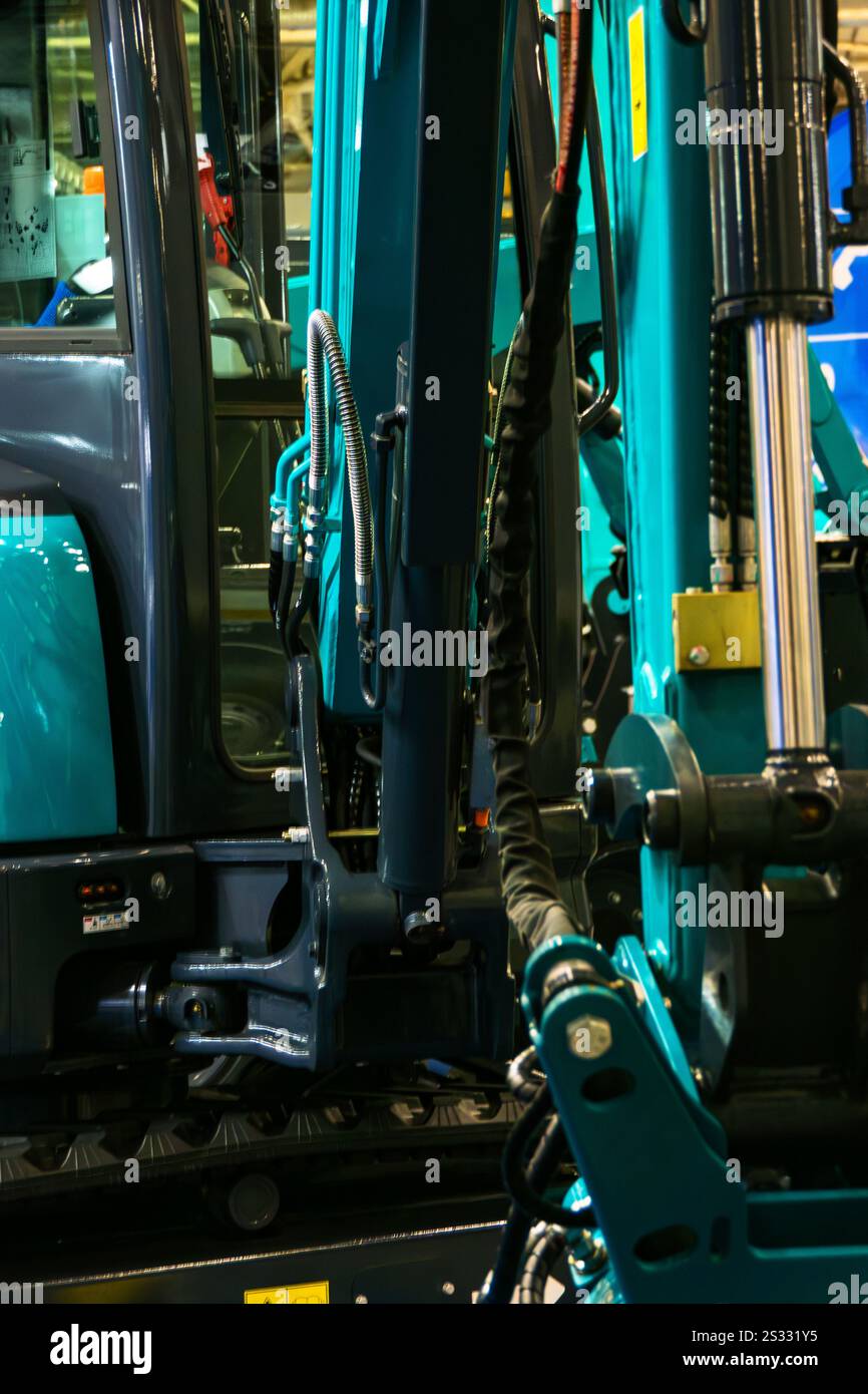 A close-up of an excavator arm and bucket. The bucket is angled ...