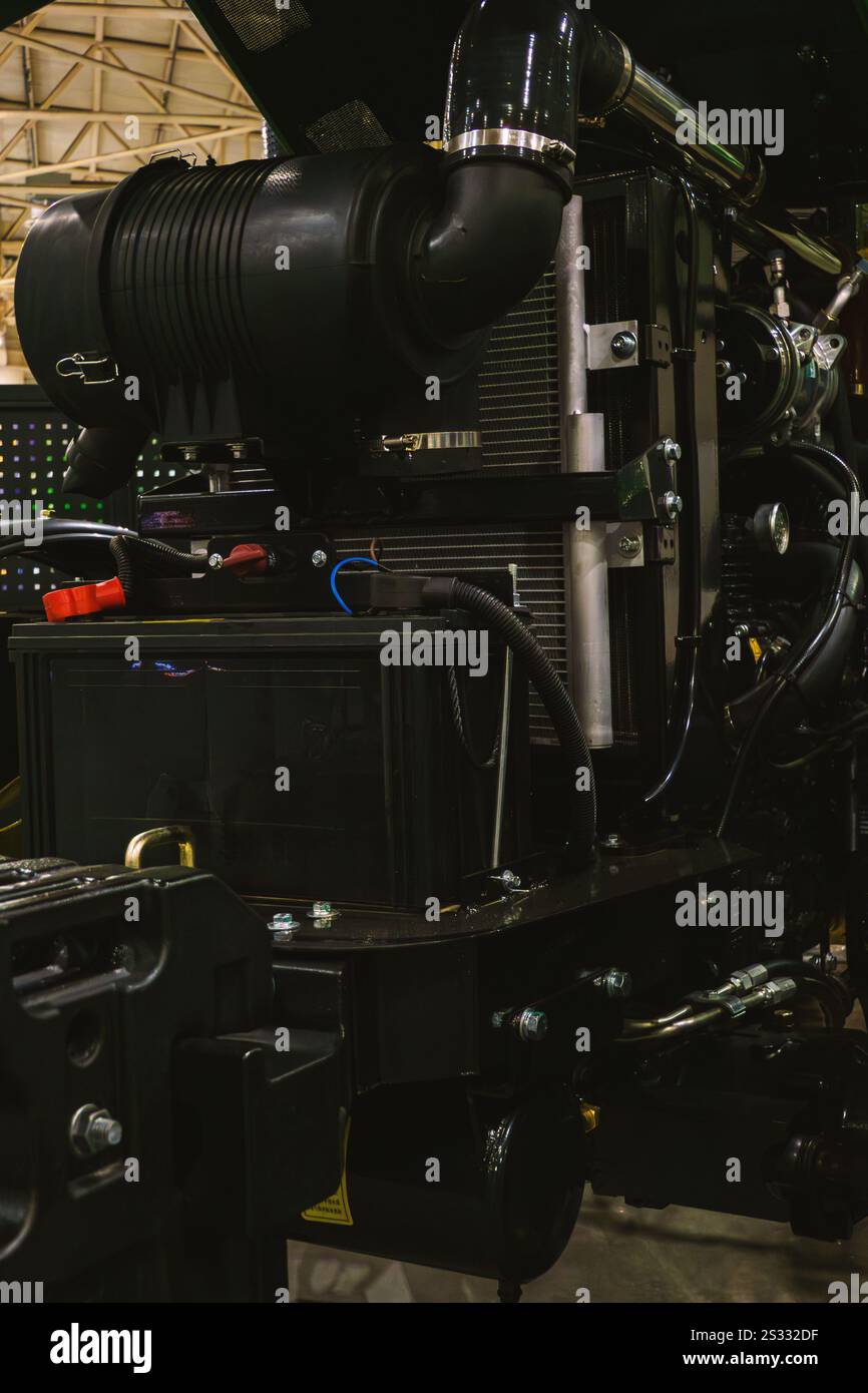 A close-up view of a modern tractor with the hood open, showcasing the ...