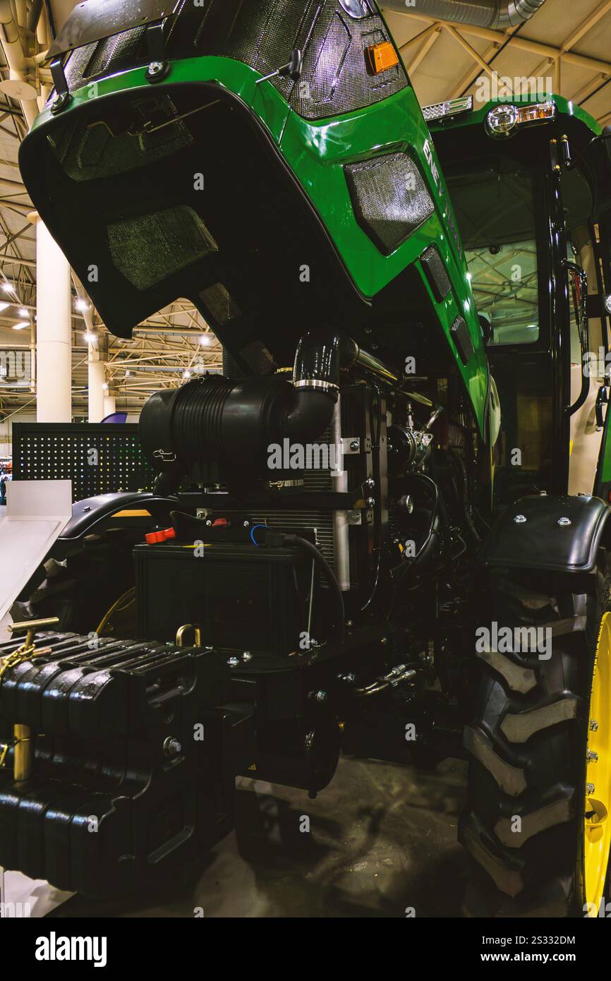 A close-up view of a modern tractor with the hood open, showcasing the ...