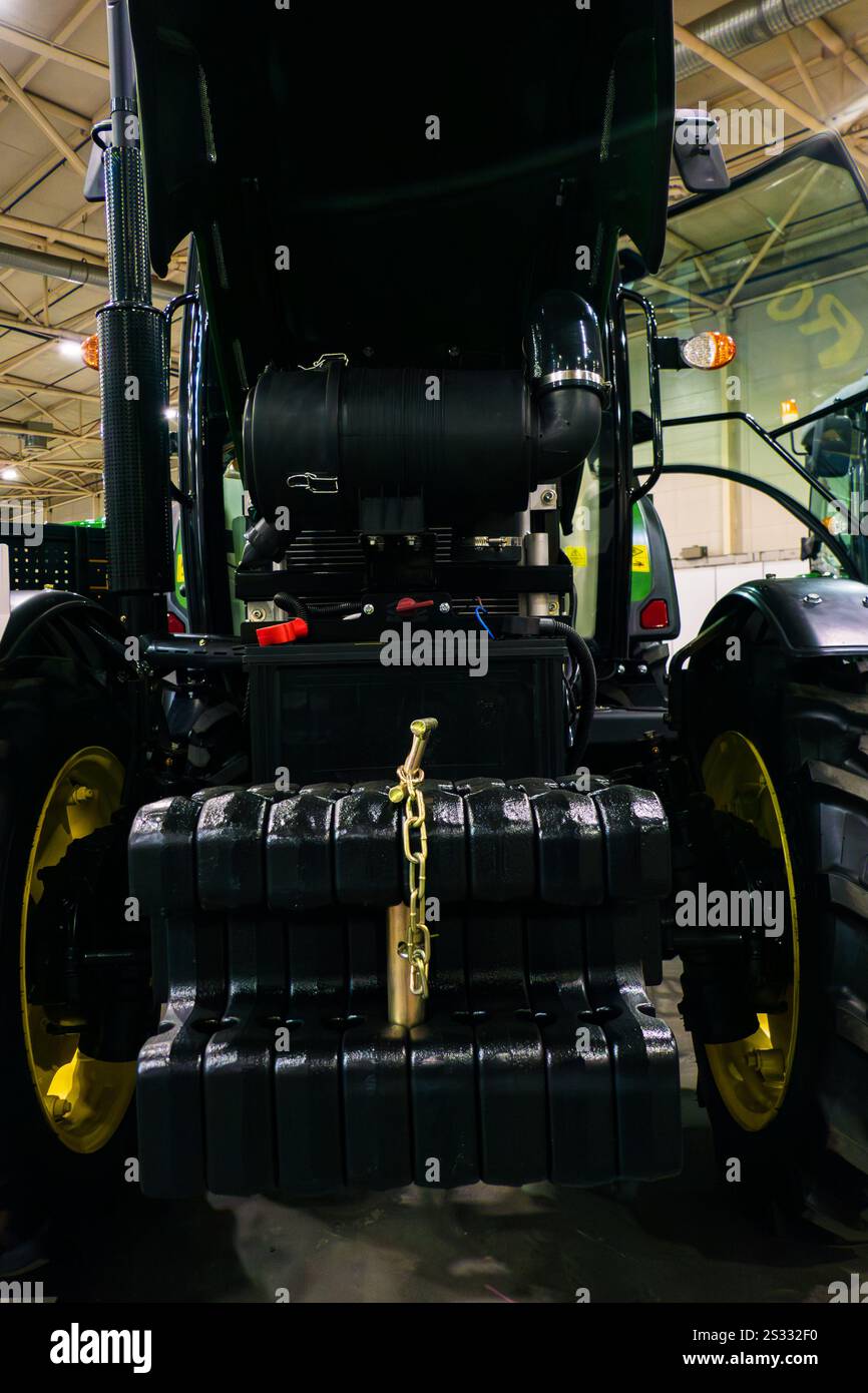 A close-up view of a modern tractor with the hood open, showcasing the ...