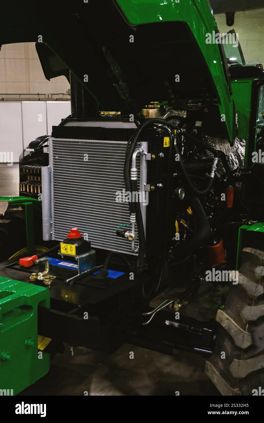 A close-up view of a modern tractor with the hood open, showcasing the ...