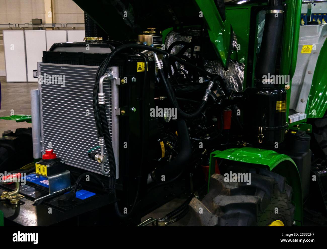 A close-up view of a modern tractor with the hood open, showcasing the ...