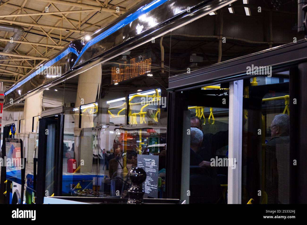 A detailed side view of a modern trolleybus, showcasing its sleek and ...