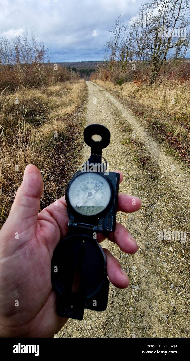 Hand holding a map and a compass, Verdun region, Meuse, Grand-Est ...
