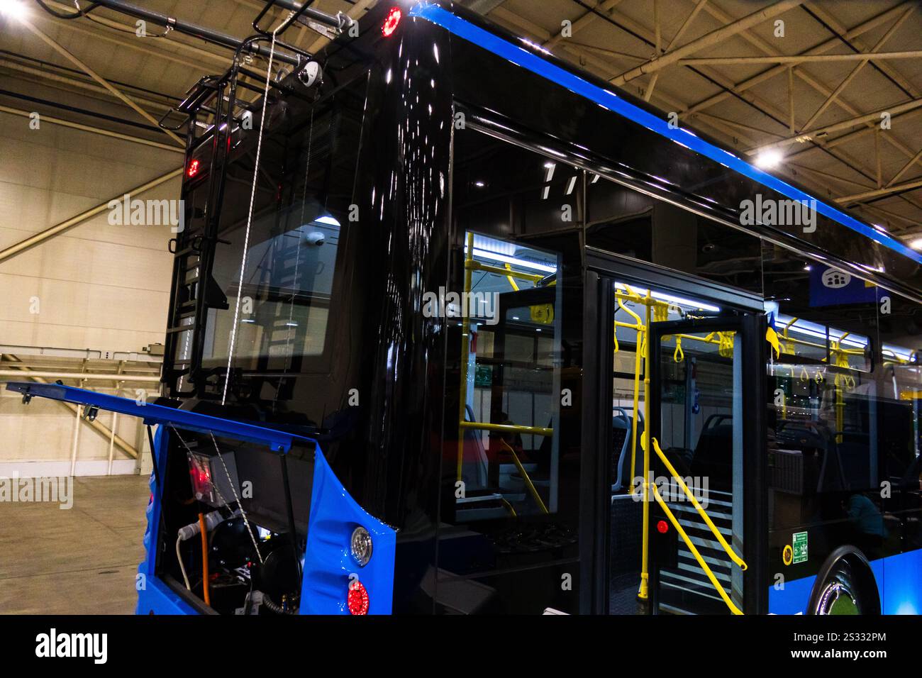Modern city bus, hybrid model, with emphasis on the rear and open door ...